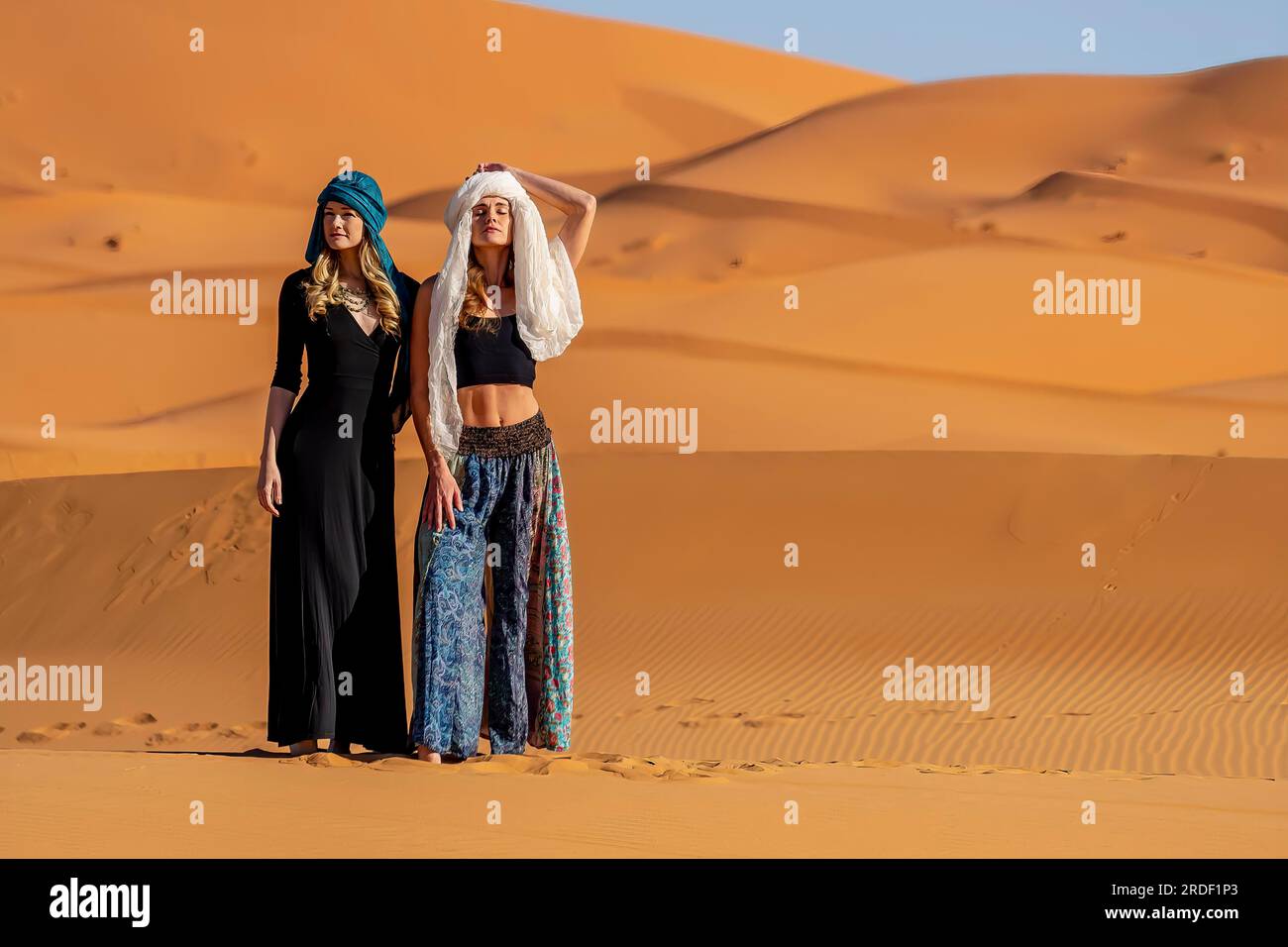 A beautiful model poses against the sand dunes in the great Sahara ...