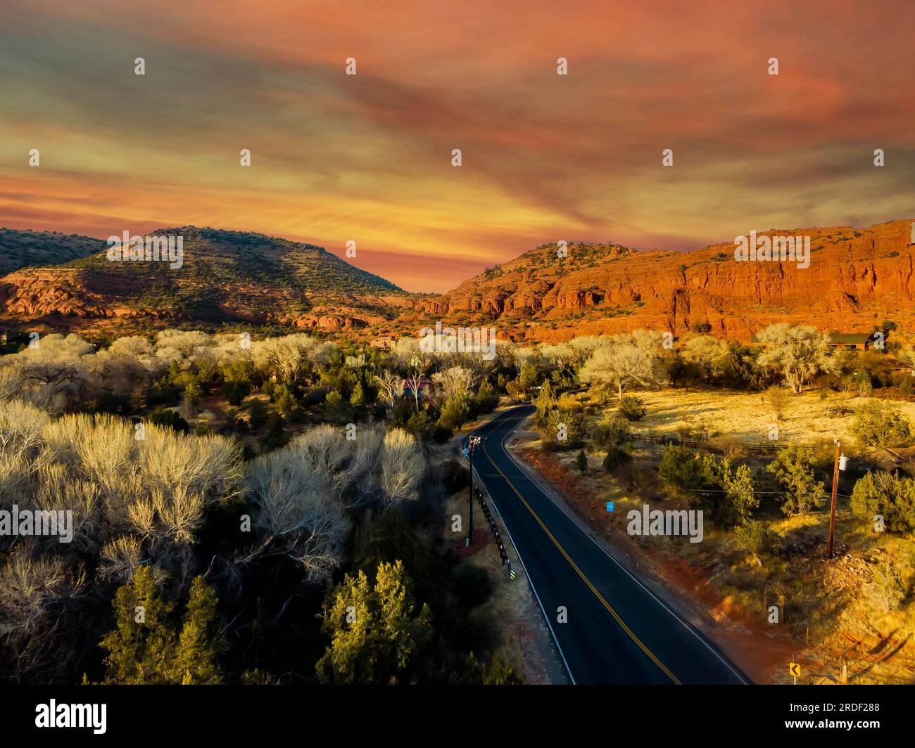 Aerial view of a rural landscape with a curvy road running through it ...
