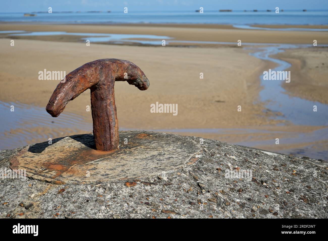 Rusty Iron Hook on a concrete pillar on a beach in Normandy, France ...