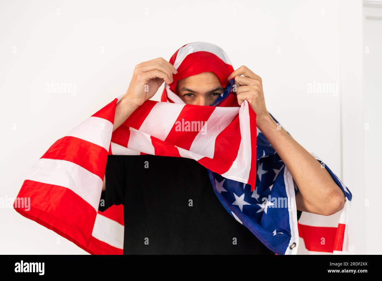 An Arab man wrapped in an American flag Stock Photo - Alamy