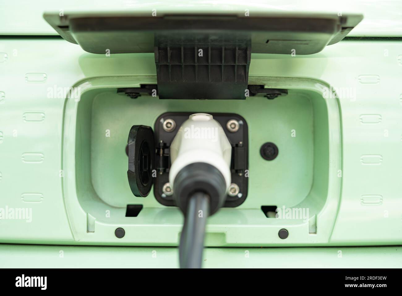 front view of an electrical car being charged horizontal composition ...