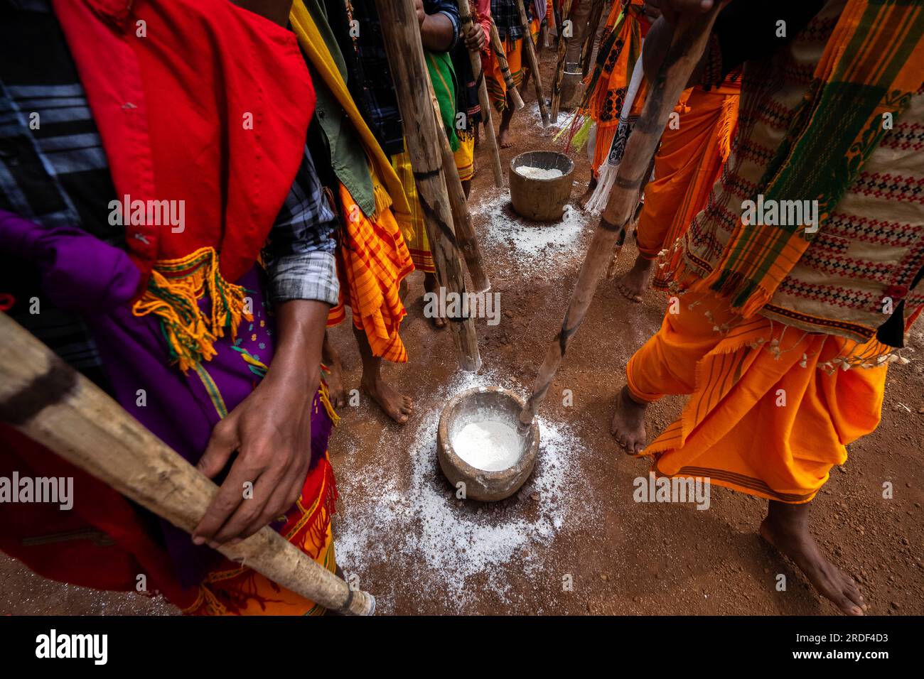 Tiwa tribal men in their traditional attire pound rice during Wanchuwa ...