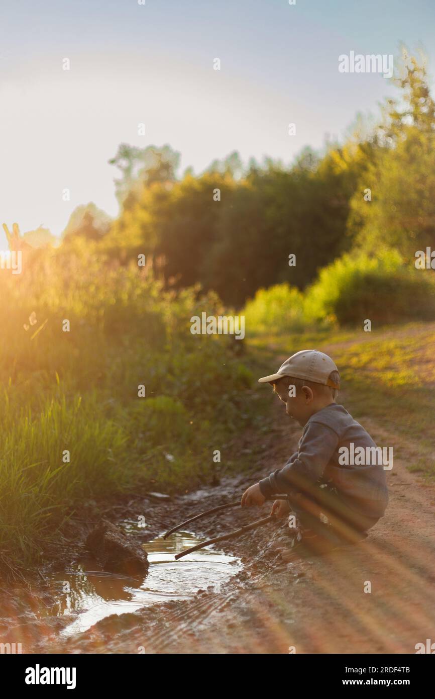 Kid sitting in puddle hi-res stock photography and images - Alamy
