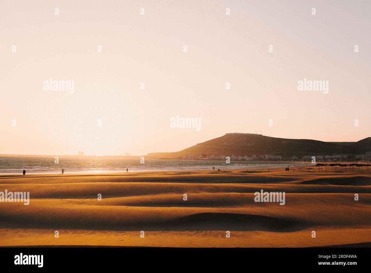 The sunset on a sandy beach in Agadir, Morocco Stock Photo - Alamy