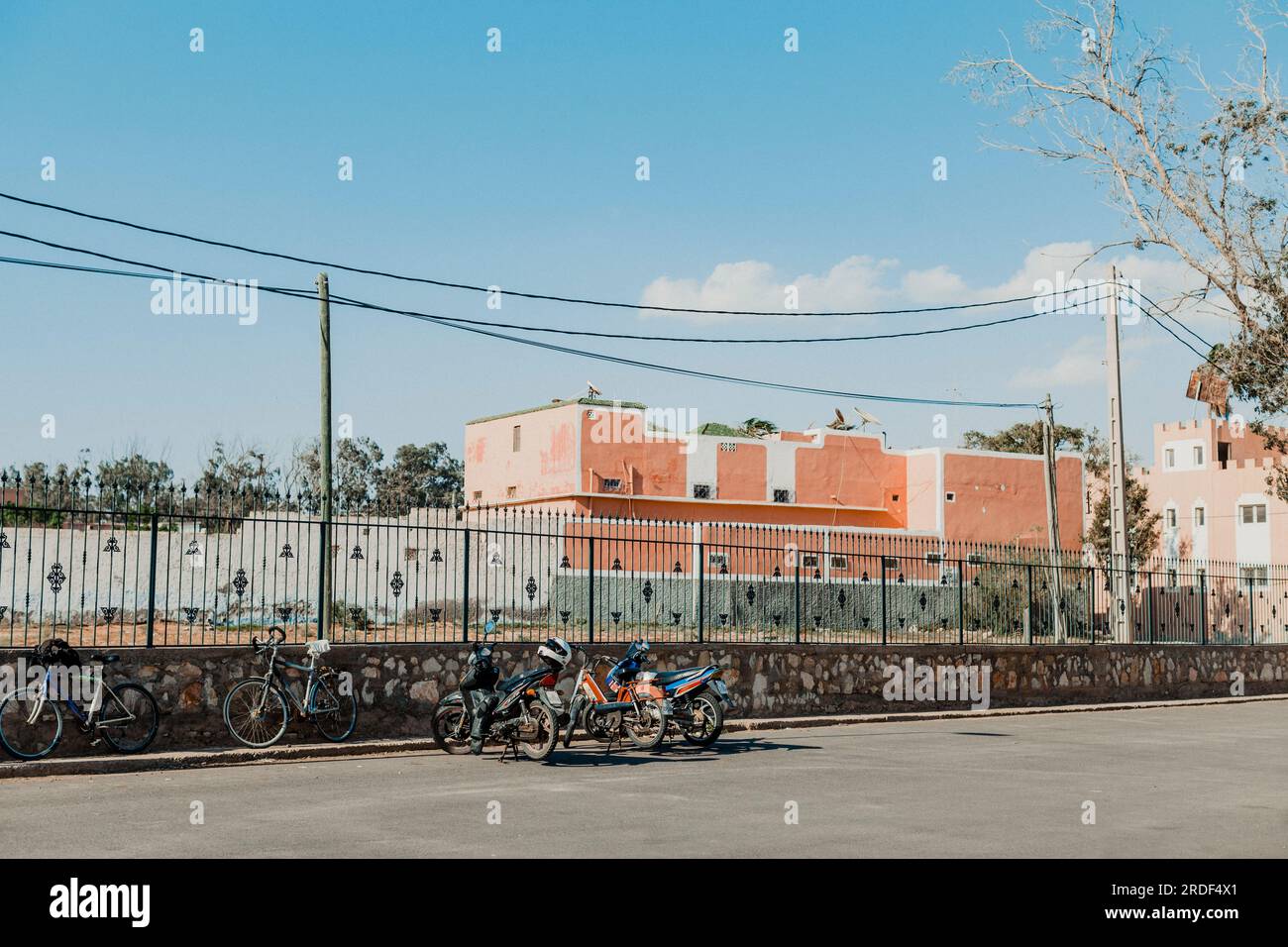 Bikes and motorcycles in an empty parking lot in Morocco Stock Photo ...