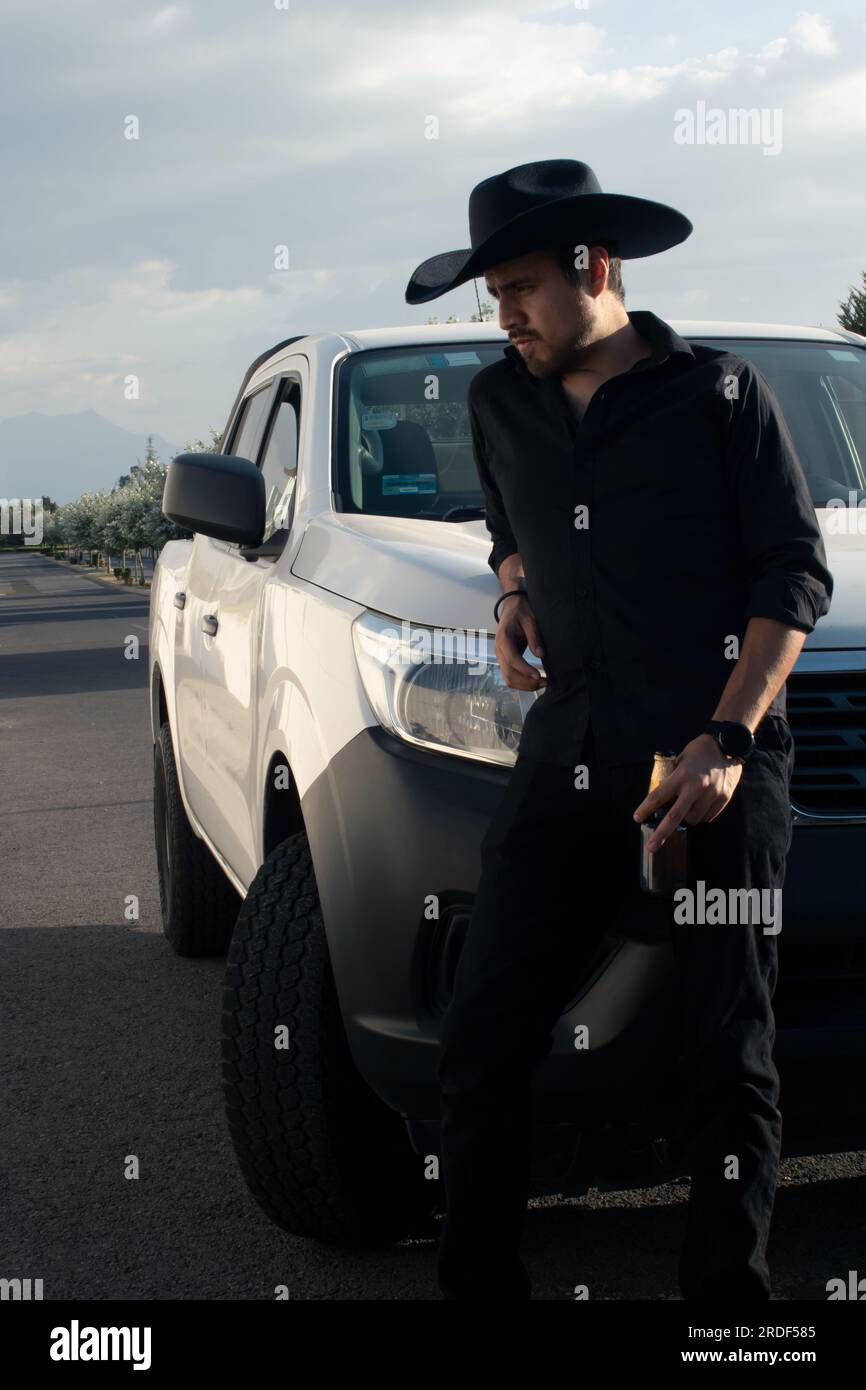 black hat cowboy on his white pickup truck Stock Photo - Alamy