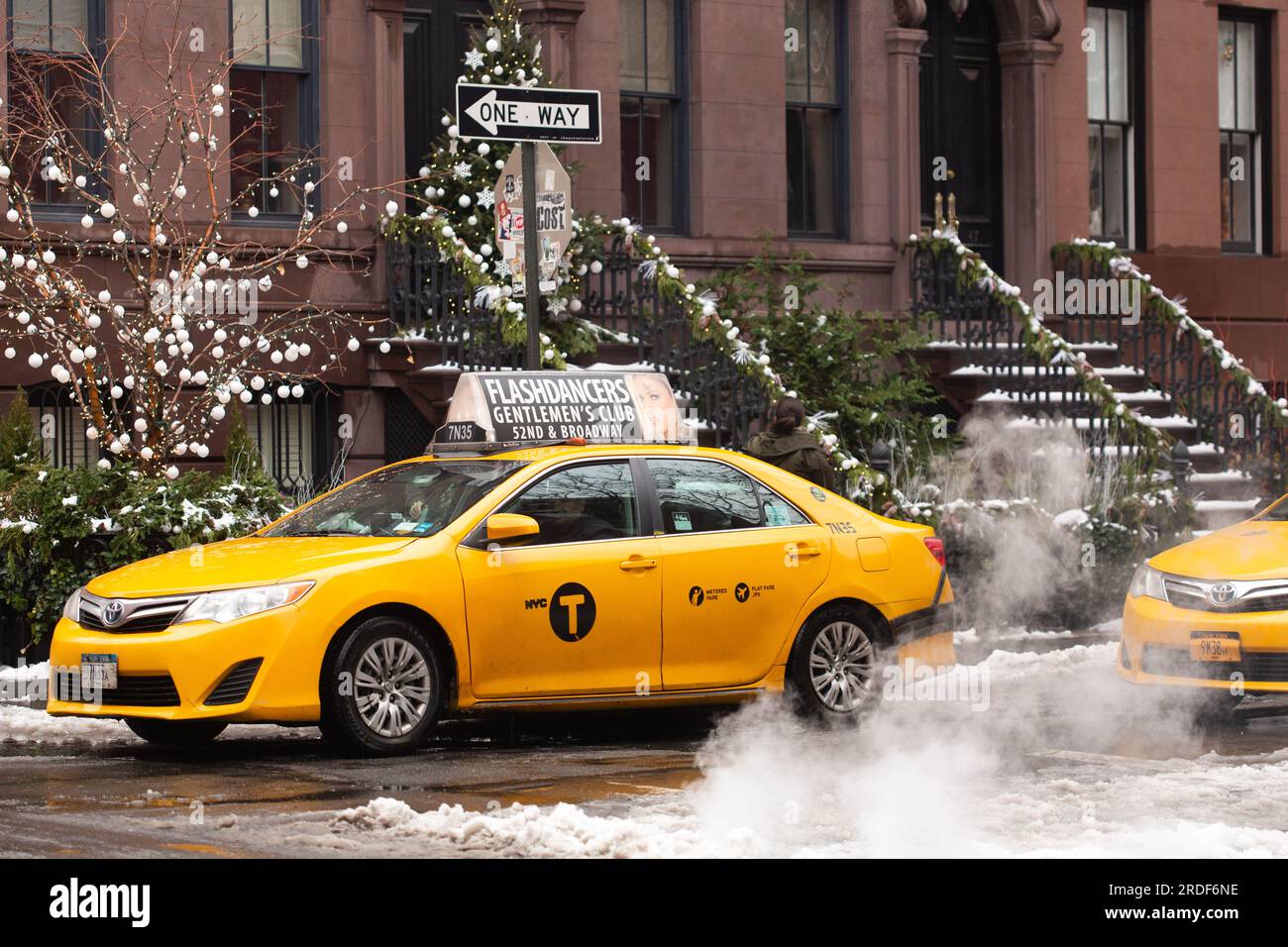 An NYC cab in front of a West Village brownstone around Christmas Stock ...