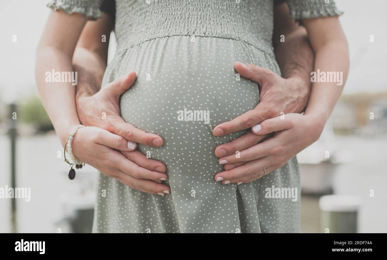 Expecting Parents with Hands on Pregnant Belly Stock Photo - Alamy