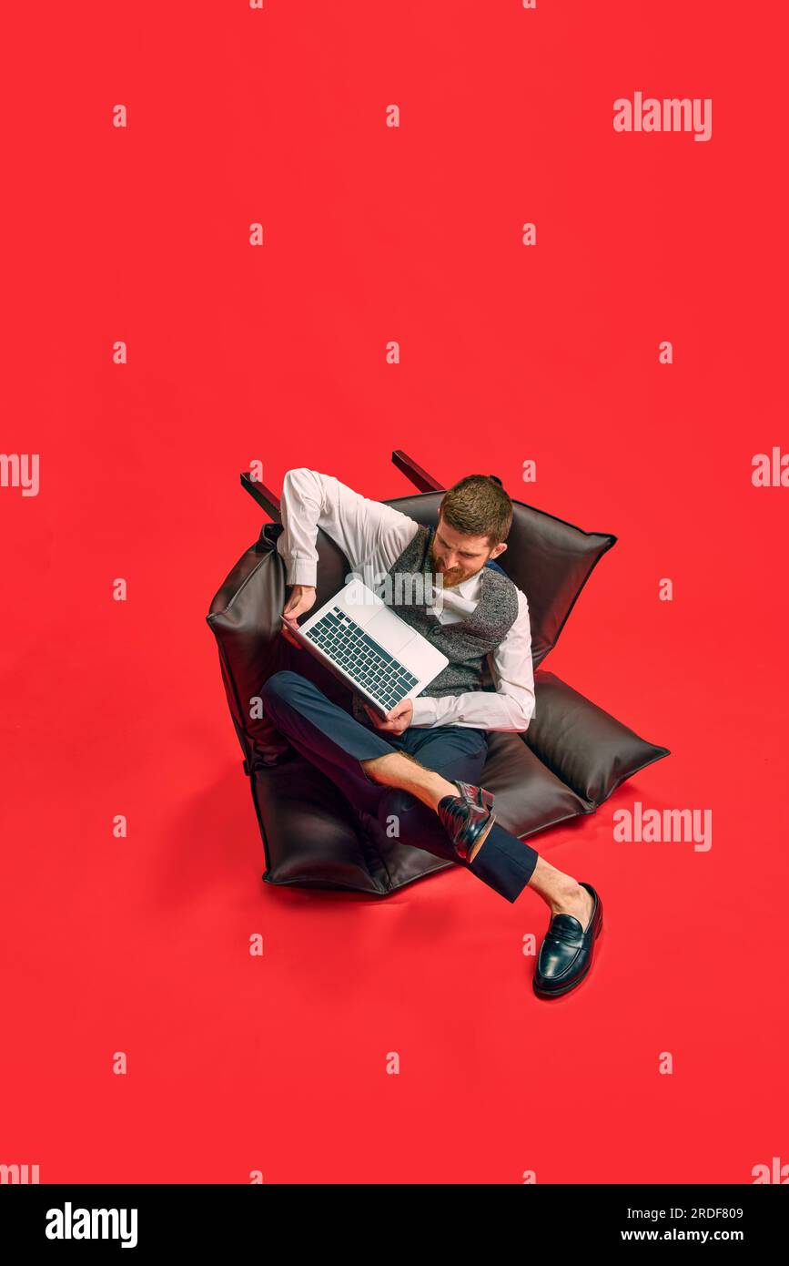 Businessman, employee sitting on armchair in weird, uncomfortable ...