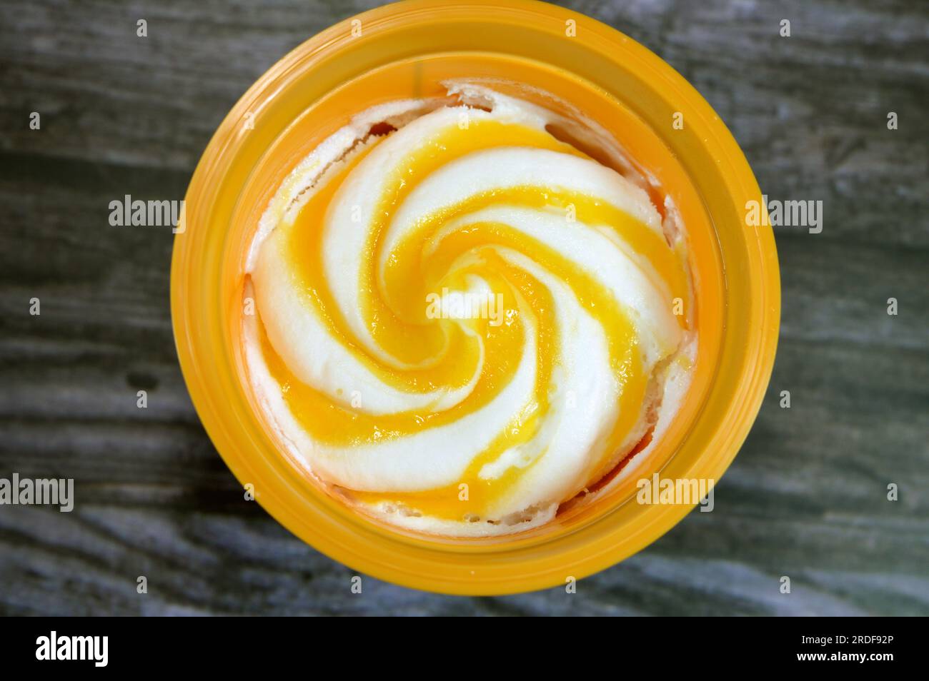 Mango sauce ice cream frozen vanilla with fruit sauce like mango or ...