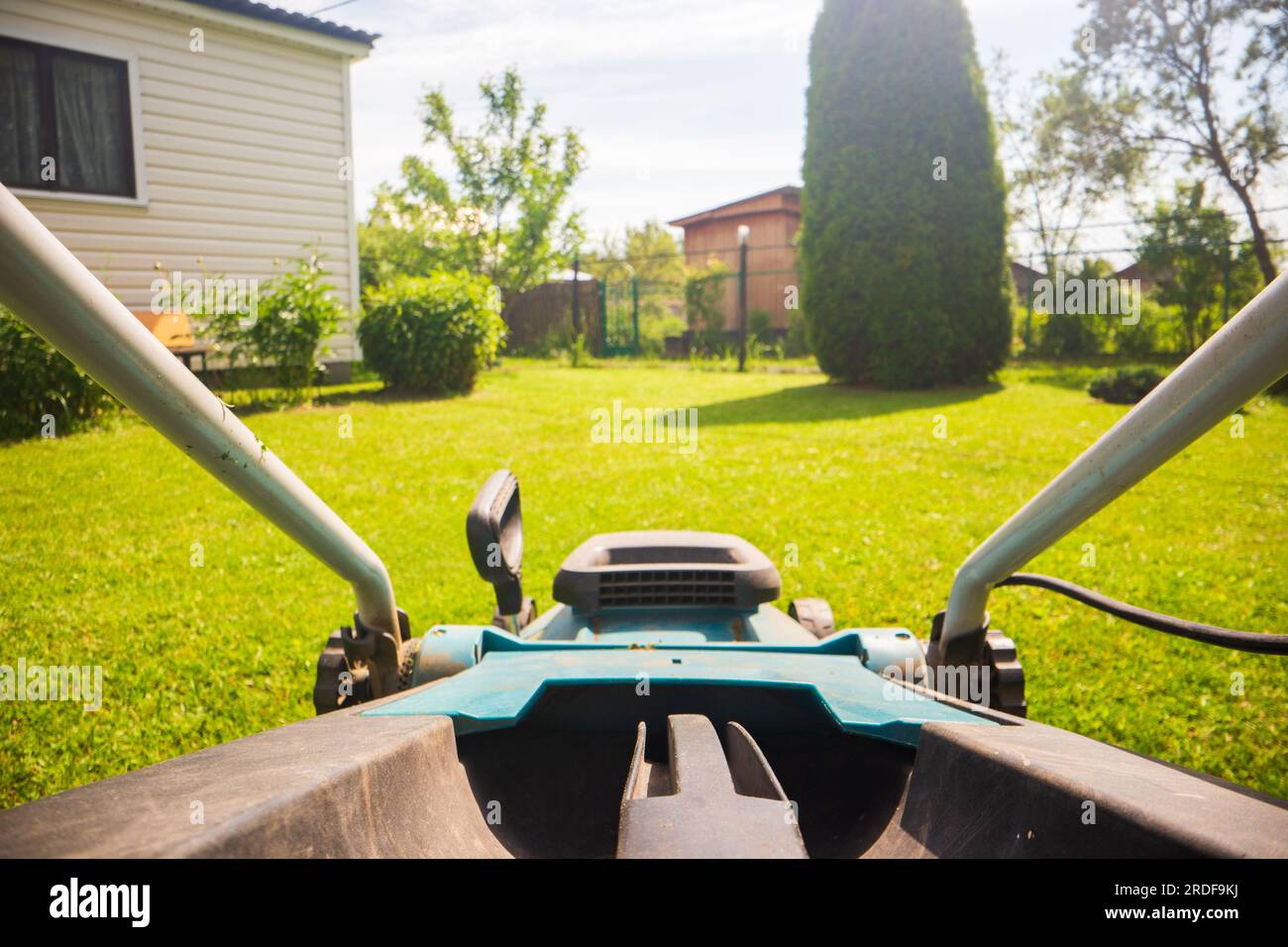 Lawn mover on green grass in modern garden or backyard. Machine for ...