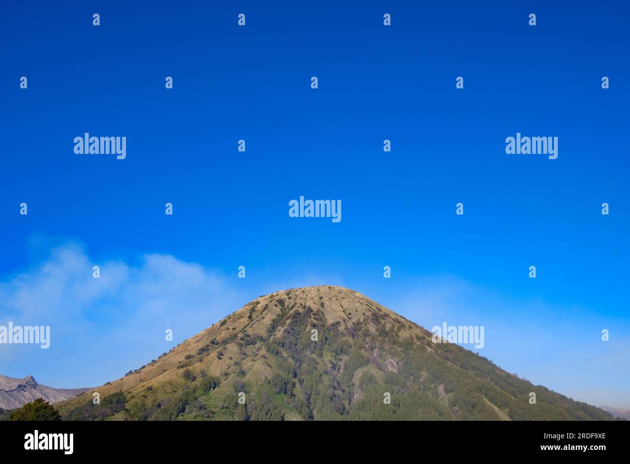 Gunung Batok or Mount Batok beside of Mount Bromo with clear blue sky ...