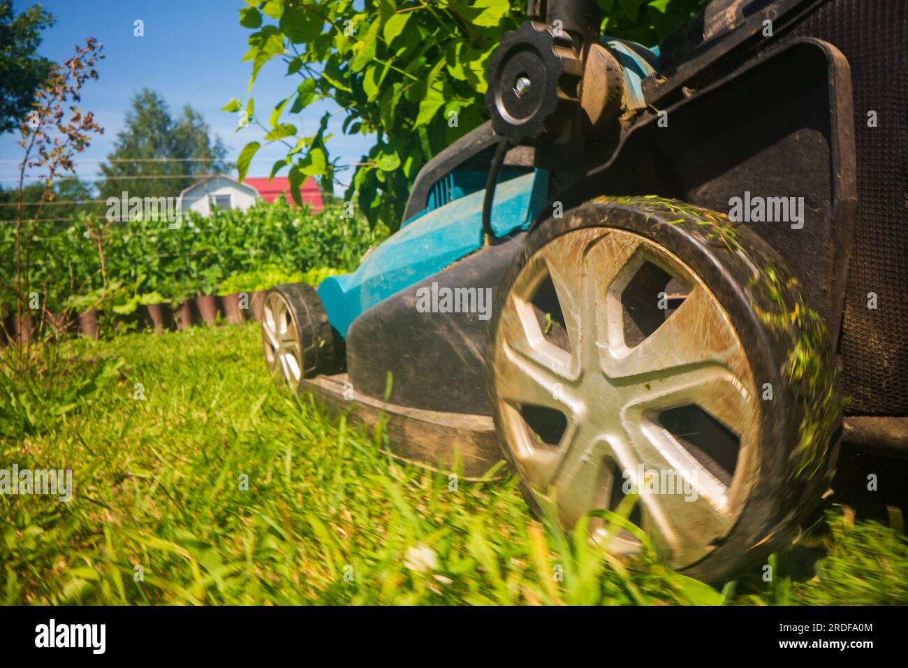 Lawn mover on green grass in modern garden or backyard. Machine for ...