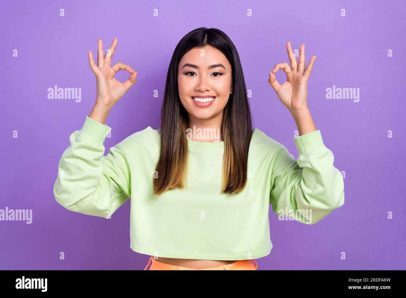 Photo of confident nice lady wear green sweatshirt smiling showing two ...