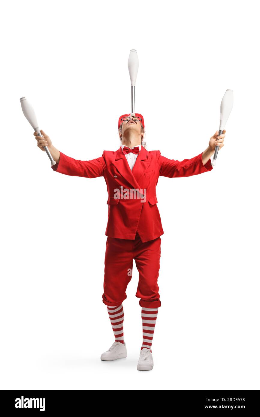 Performer in a red suit holding juggling clubs with head isolated on ...