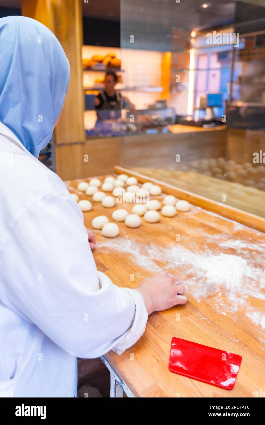 Arab woman baker in the bakery workshop workshop of artisan bakery ...