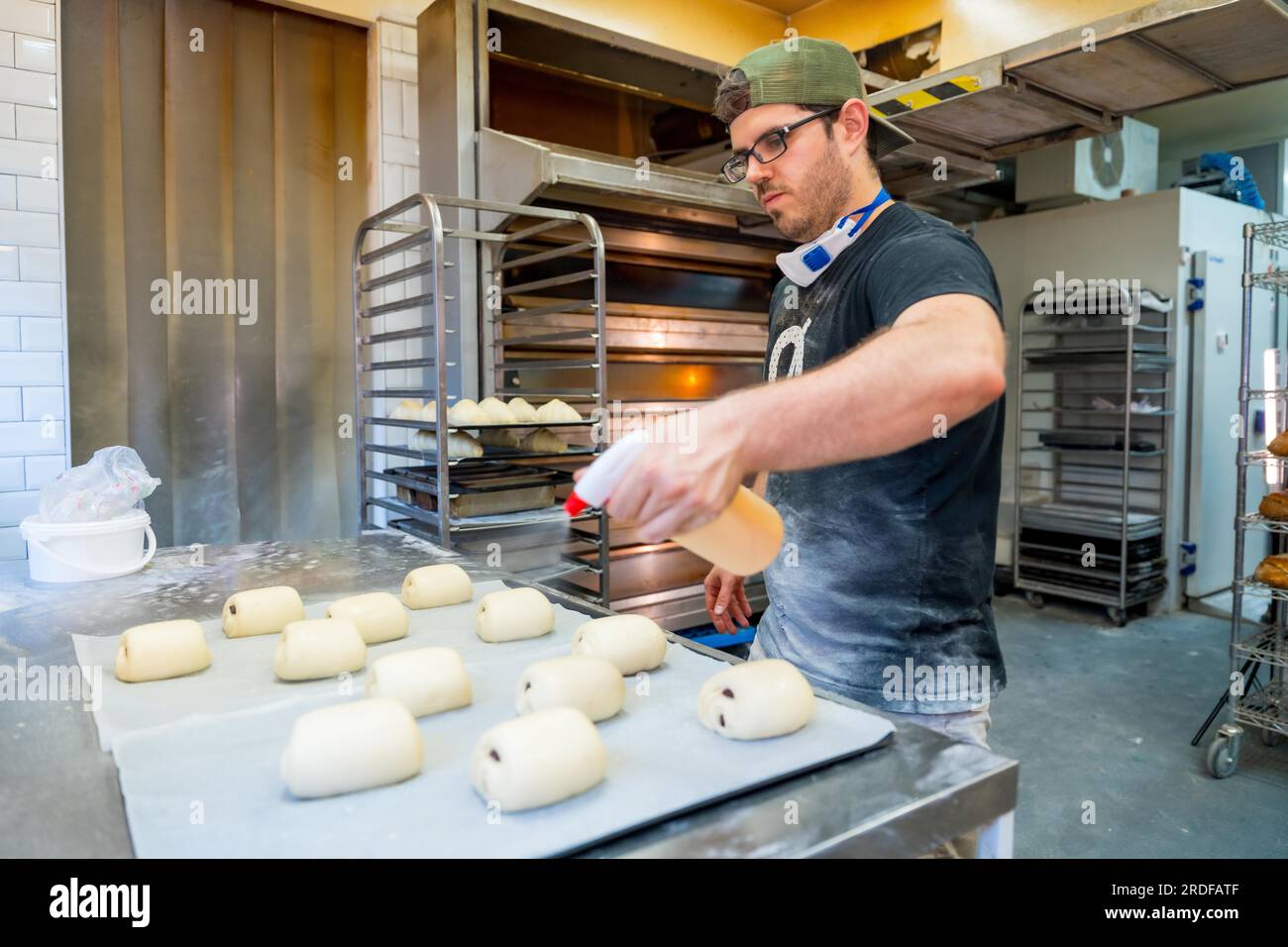 Baker of bakery in the workshop workshop of artisan bakery preparing croissant and neapolitan on ...