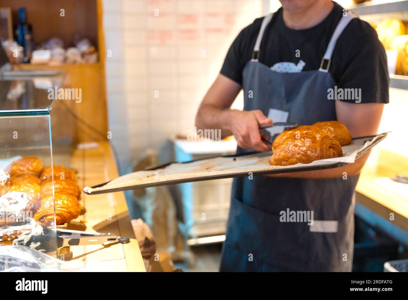 Bakery baker in workshop workshop of artisan bakery and shop placing ...
