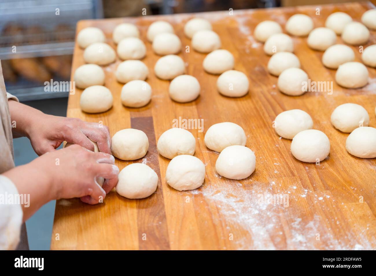 Hands of female baker in the bakery workshop of artisan bakery ...