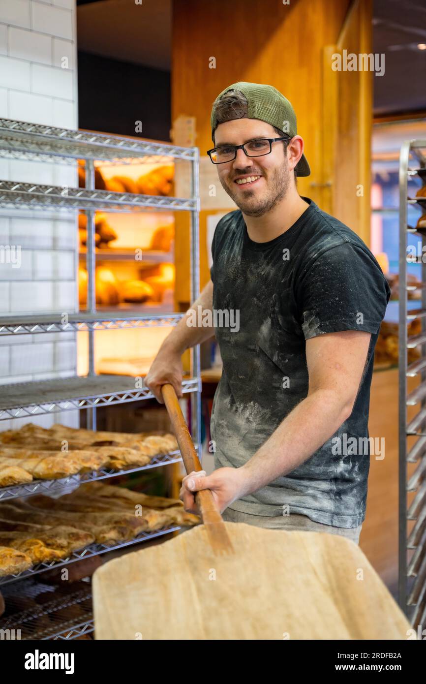 Portrait of baker of bakery in the workshop workshop of artisan bakery with the shovel of bread ...