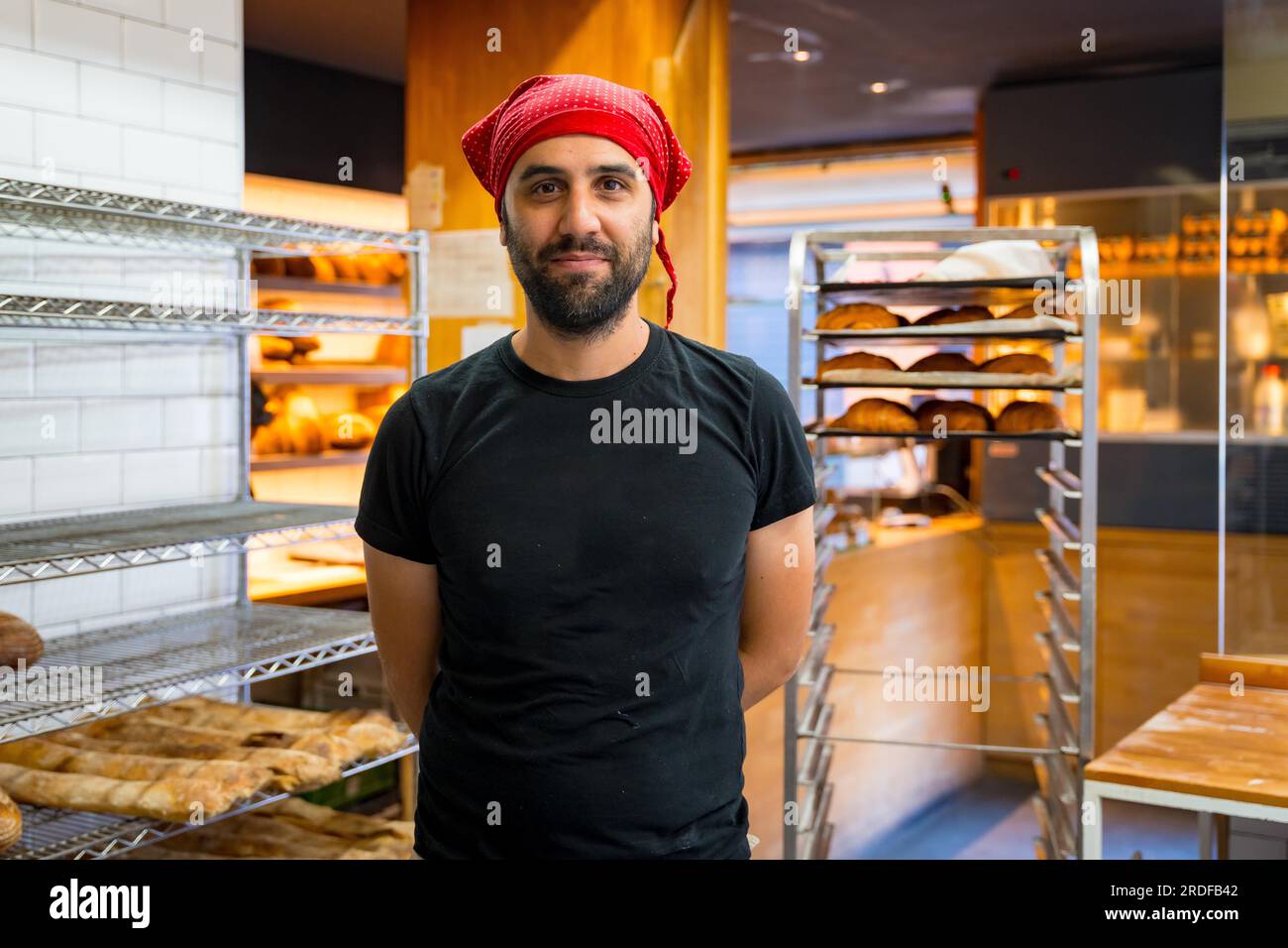 Corporate portrait of bakery manager in workshop of artisan bakery ...