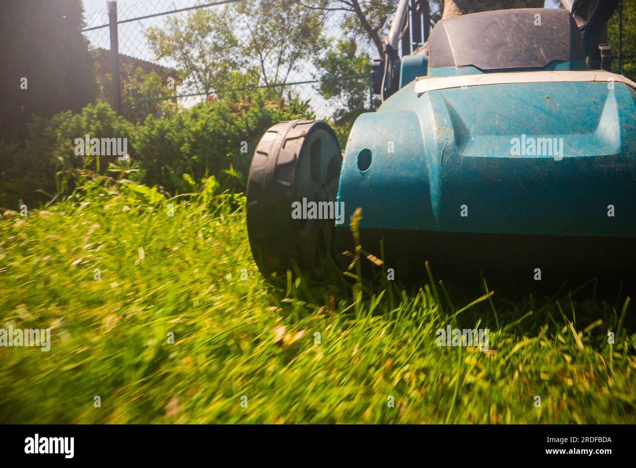 Lawn mover on green grass in modern garden or backyard. Machine for ...