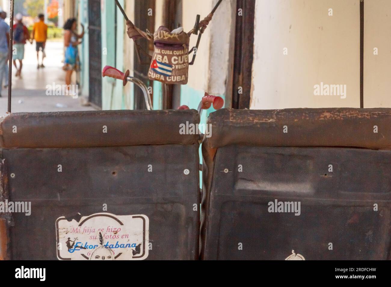 Havana, Cuba - May 27, 2023: Rear view of rusty seats in a bicitaxi or ...