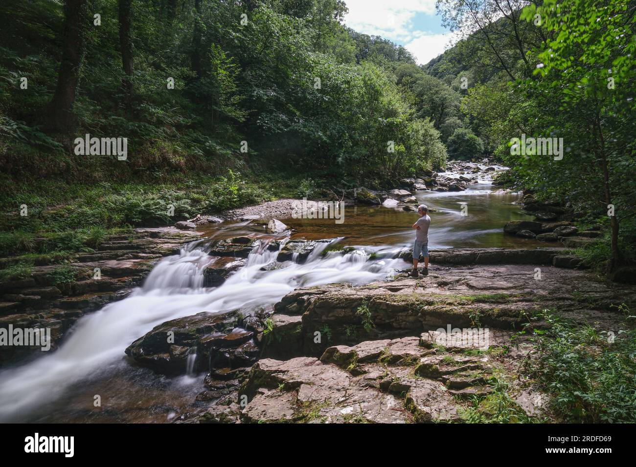 Man standing by where the two rivers East Lyn and Hoar Oak Water ...