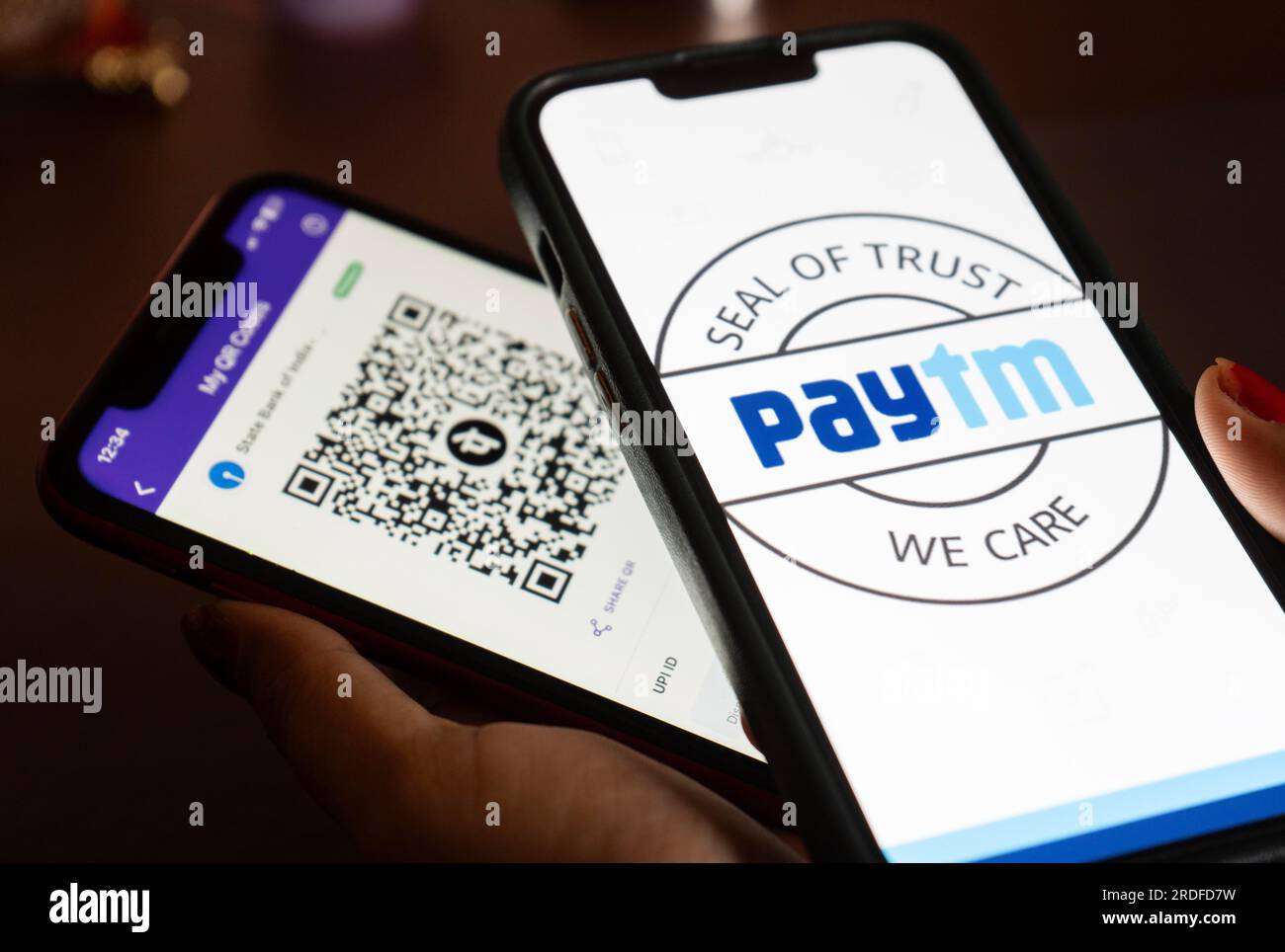 In this photo illustration, the Paytm logo and PhonePe QR code, is seen displayed on mobile ...