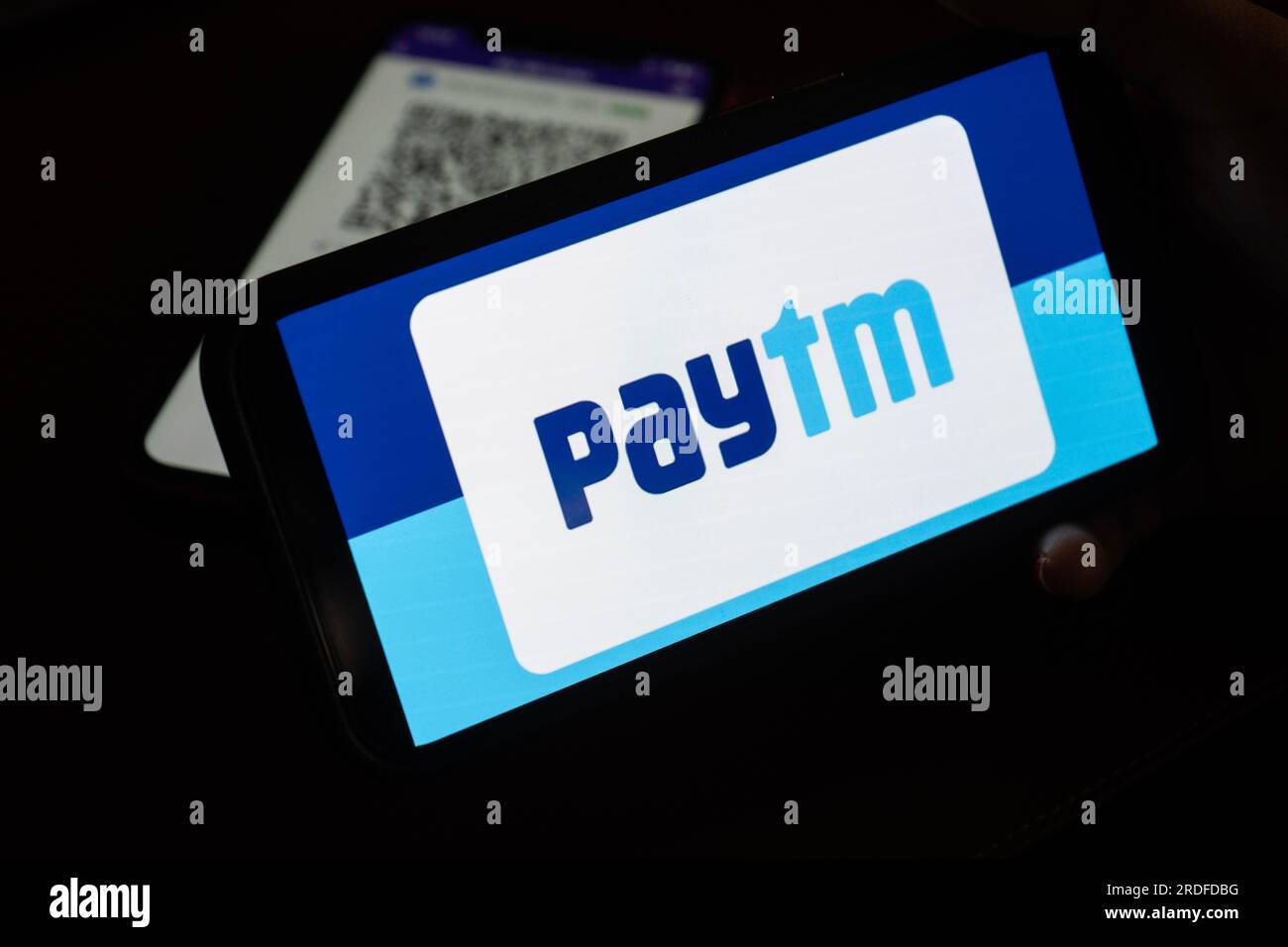 In this photo illustration, the Paytm logo and PhonePe QR code, is seen displayed on mobile ...