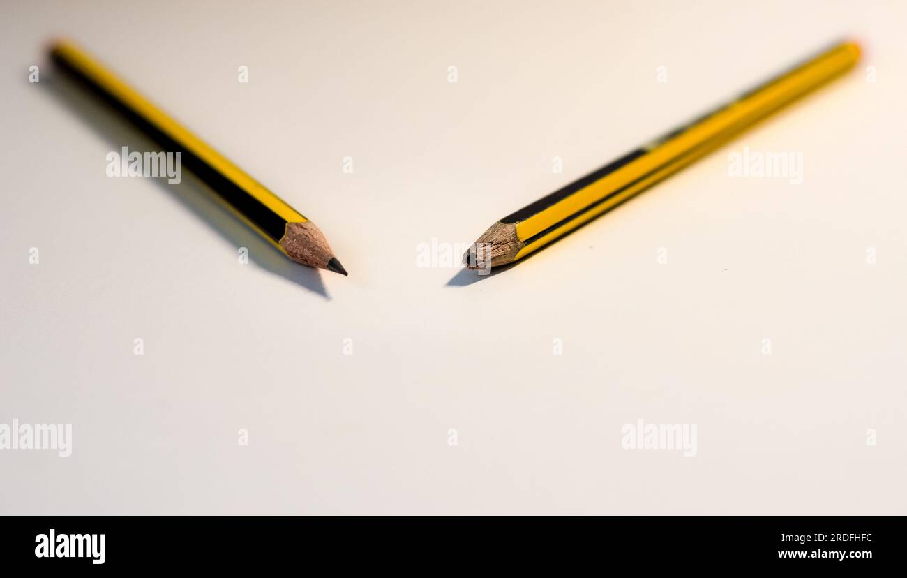 CLOSEUP PHOTOGRAPH OF TWO PENCILS, ONE WITH A SHARP END AND ANOTHER ...
