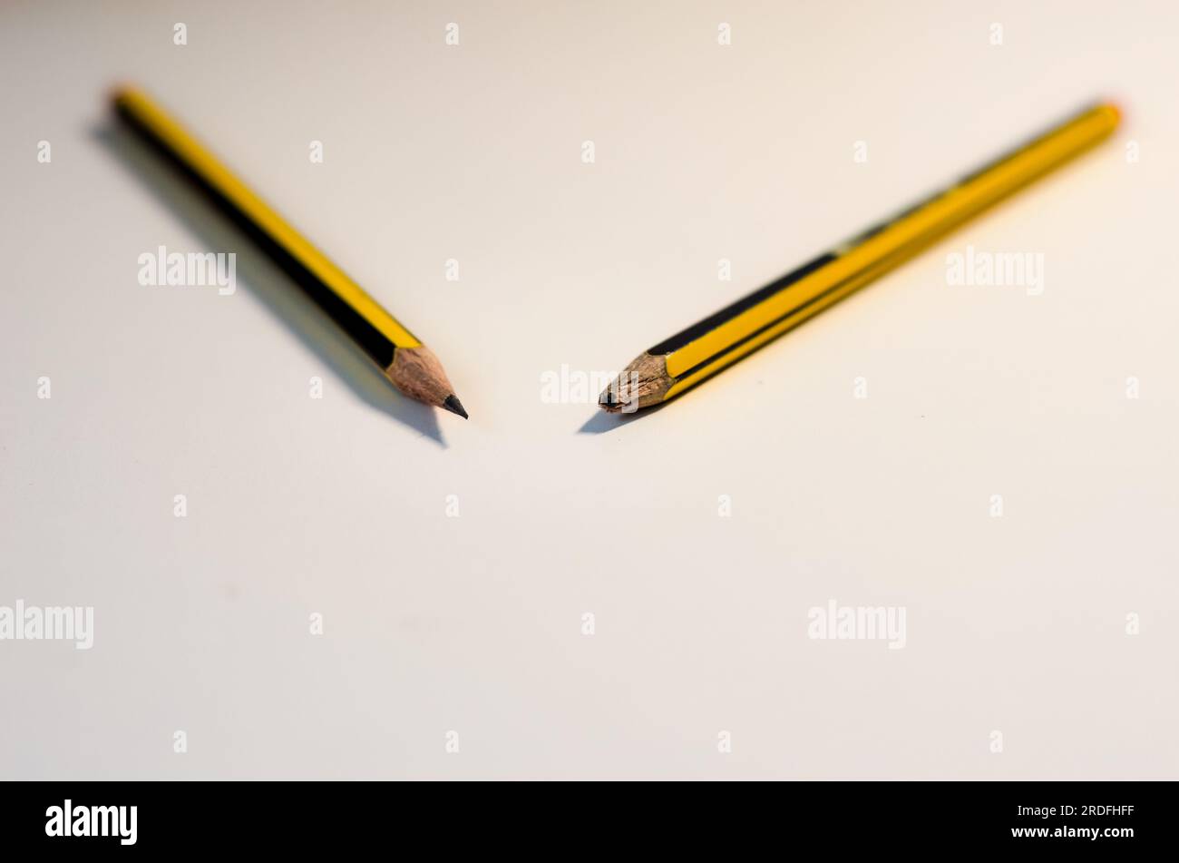 CLOSEUP PHOTOGRAPH OF TWO PENCILS, ONE WITH A SHARP END AND ANOTHER ...