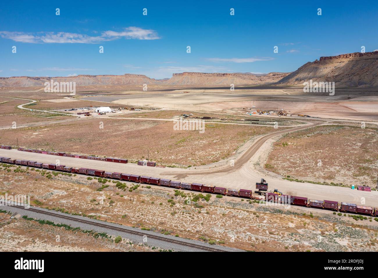 A reachstacker container handler removes containers of uranium tailings ...