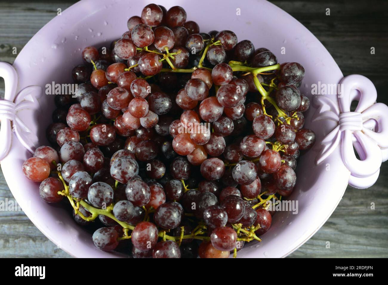 Red grapes, a fruit, botanically a berry of the deciduous woody vines ...