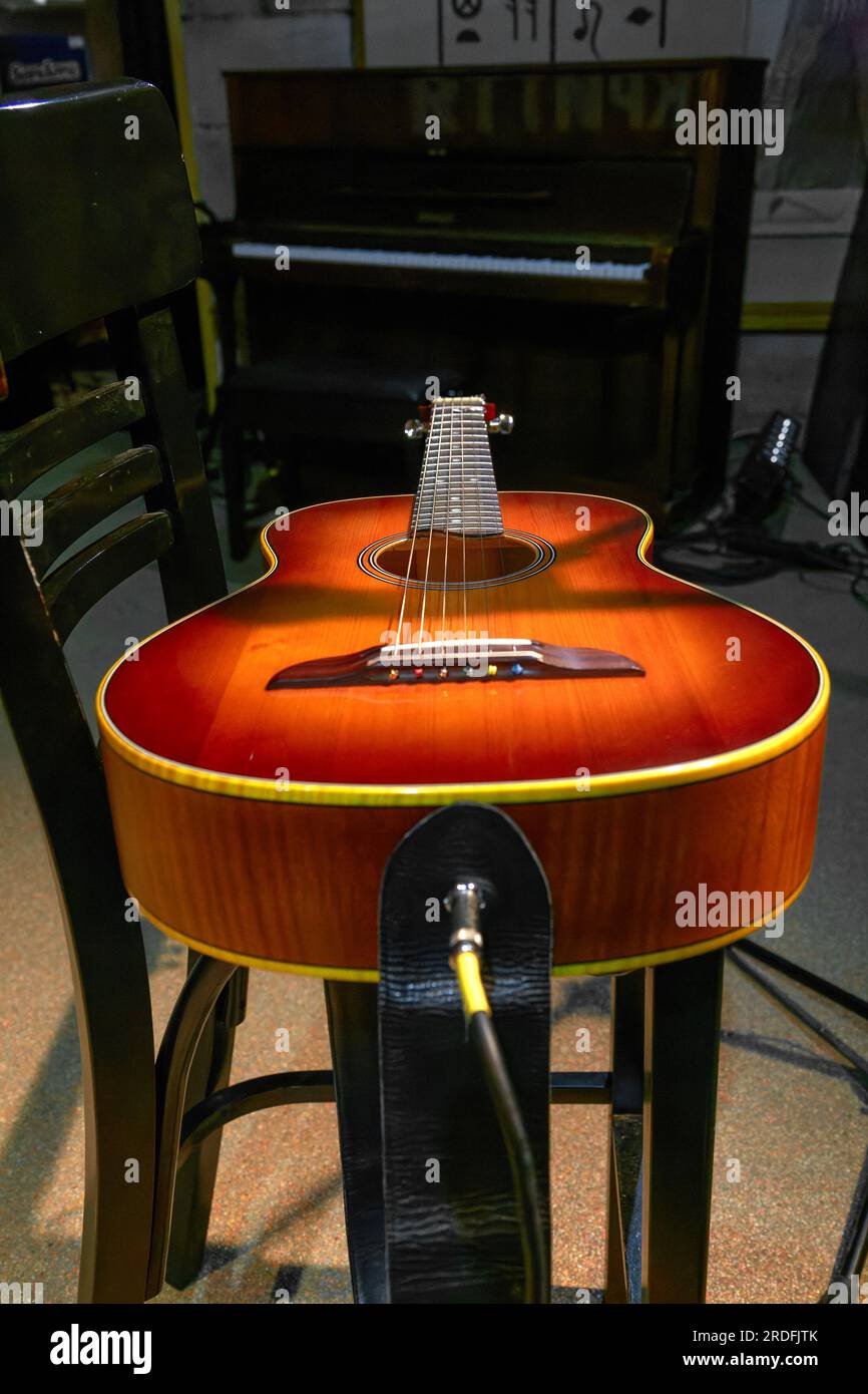 Image musical instrument acoustic guitar lies on a chair Stock Photo ...