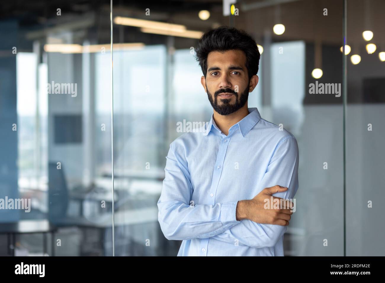 Portrait of a young successful Indian male programmer, developer ...