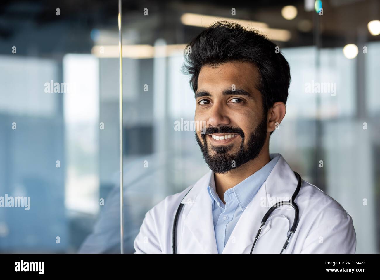 Close-up photo. Portrait of a young Indian male medical student, intern ...