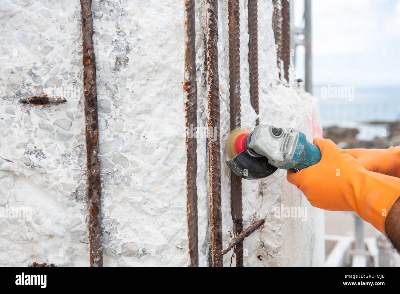 Construction worker with angle grinder polishing rods Stock Photo - Alamy