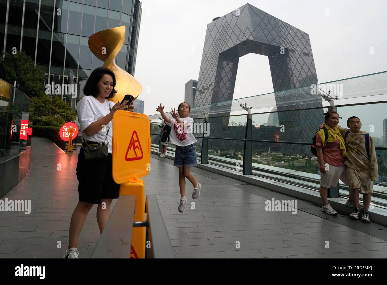 Visitors enjoy a view of the iconic CCTV tower from a platform in ...