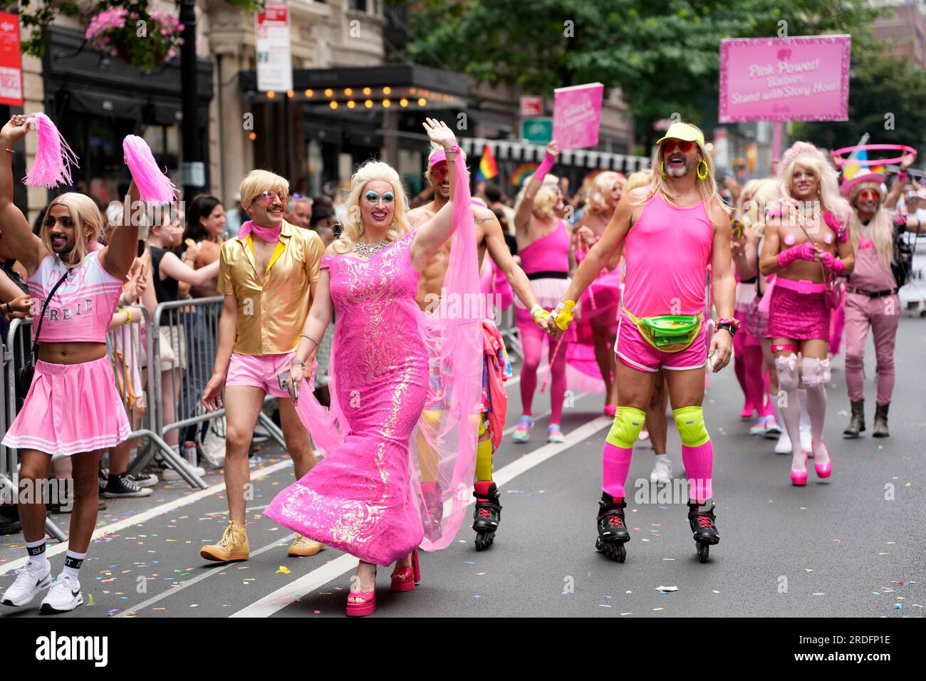 FILE - Parade-goers promoting the upcoming "Barbie" movie walk in the ...