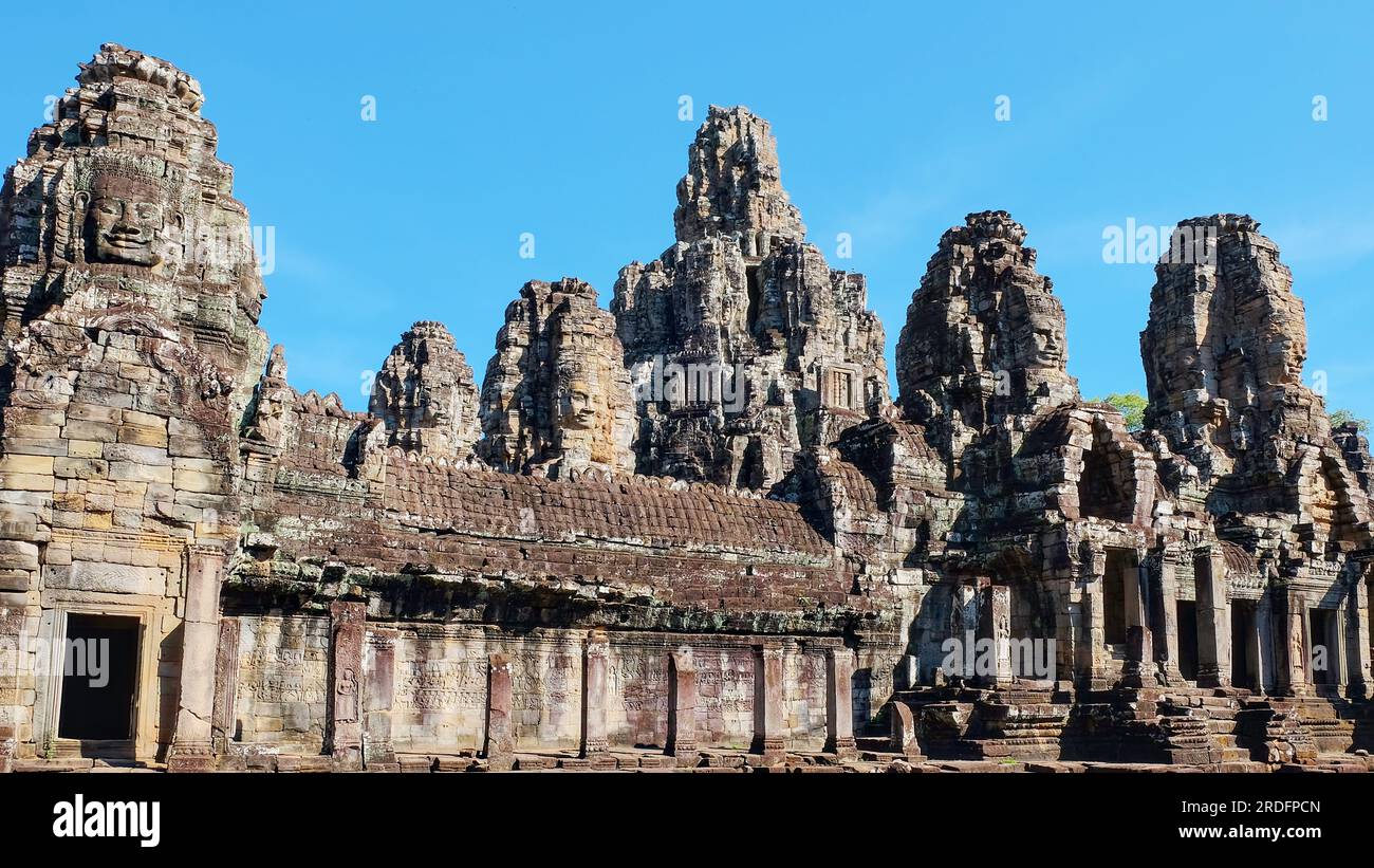 General view of the Bayon Temple in Cambodia, stone towers with human ...