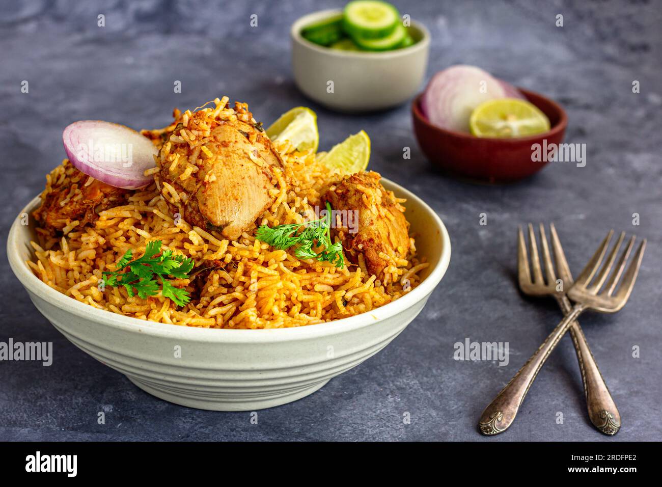 Indian Chicken Biryani with Onion, Cucumber and Lemon Low Angle Close ...