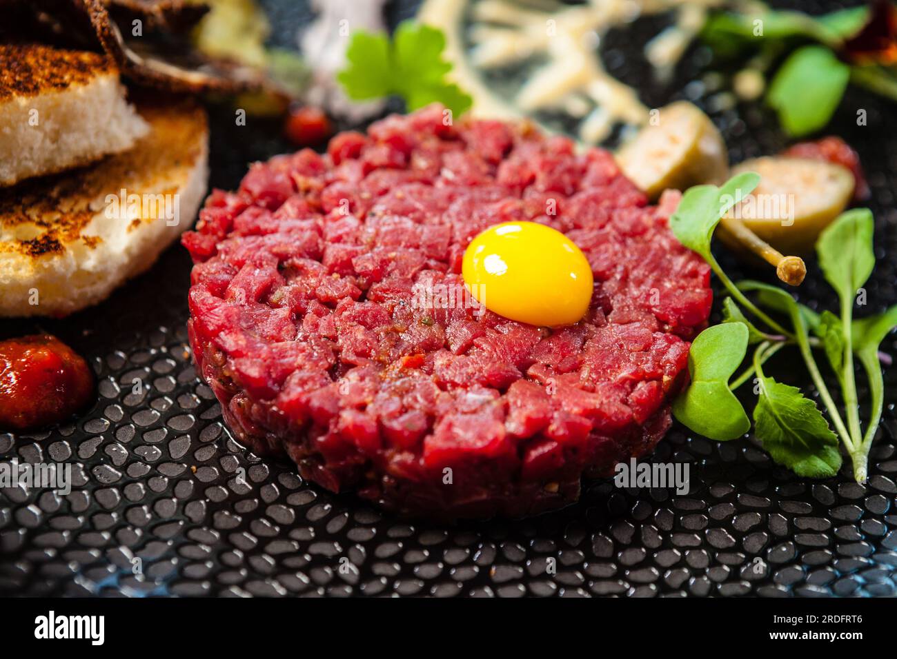 Beef tartare from Black Angus. Onion, quail egg, tomato sauce, mustard ...