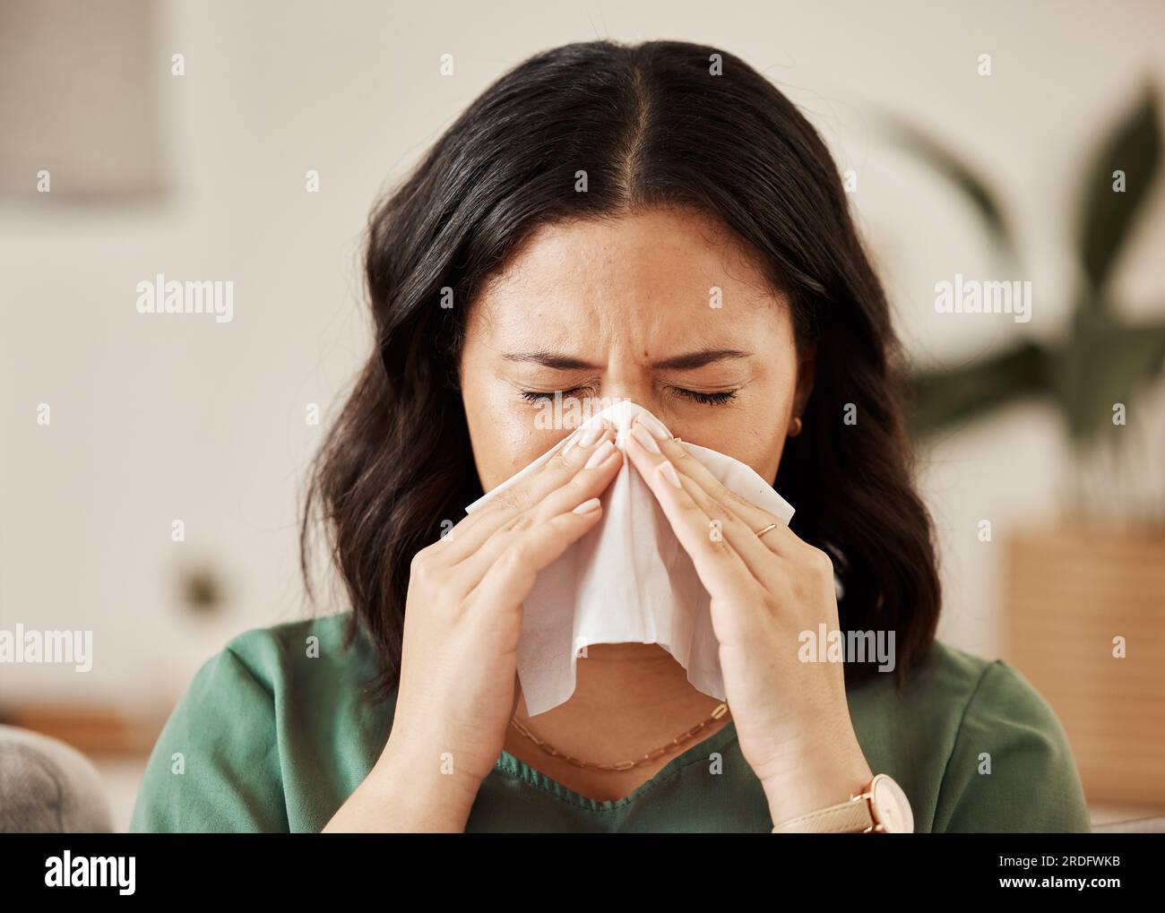 Blowing nose, tissue and woman in a living room with flu, cold and hay ...
