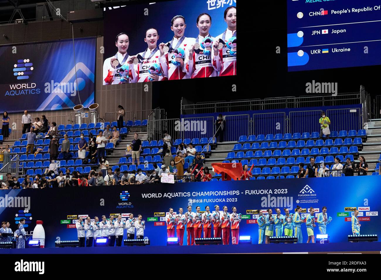 China team, center, with gold medals, Japan team, left, with silver ...