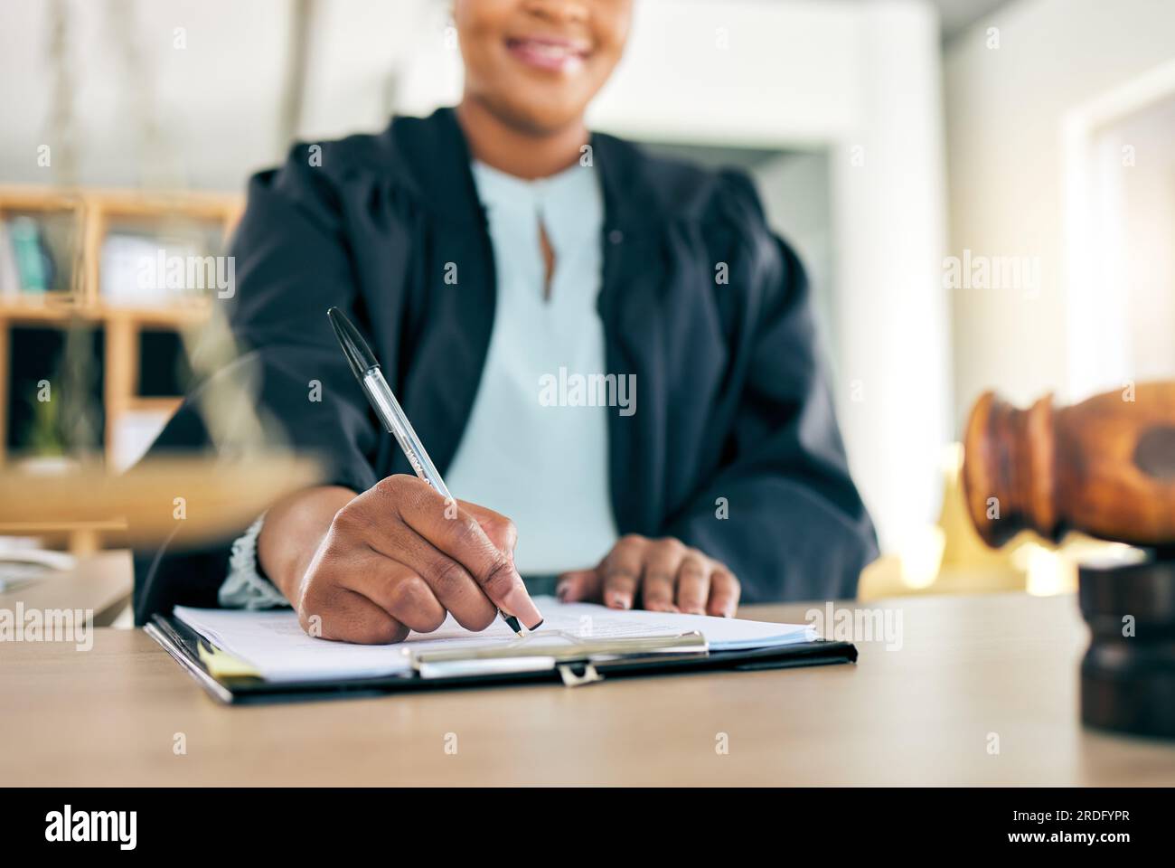 Legal, scale and hands of black woman lawyer writing for an ...