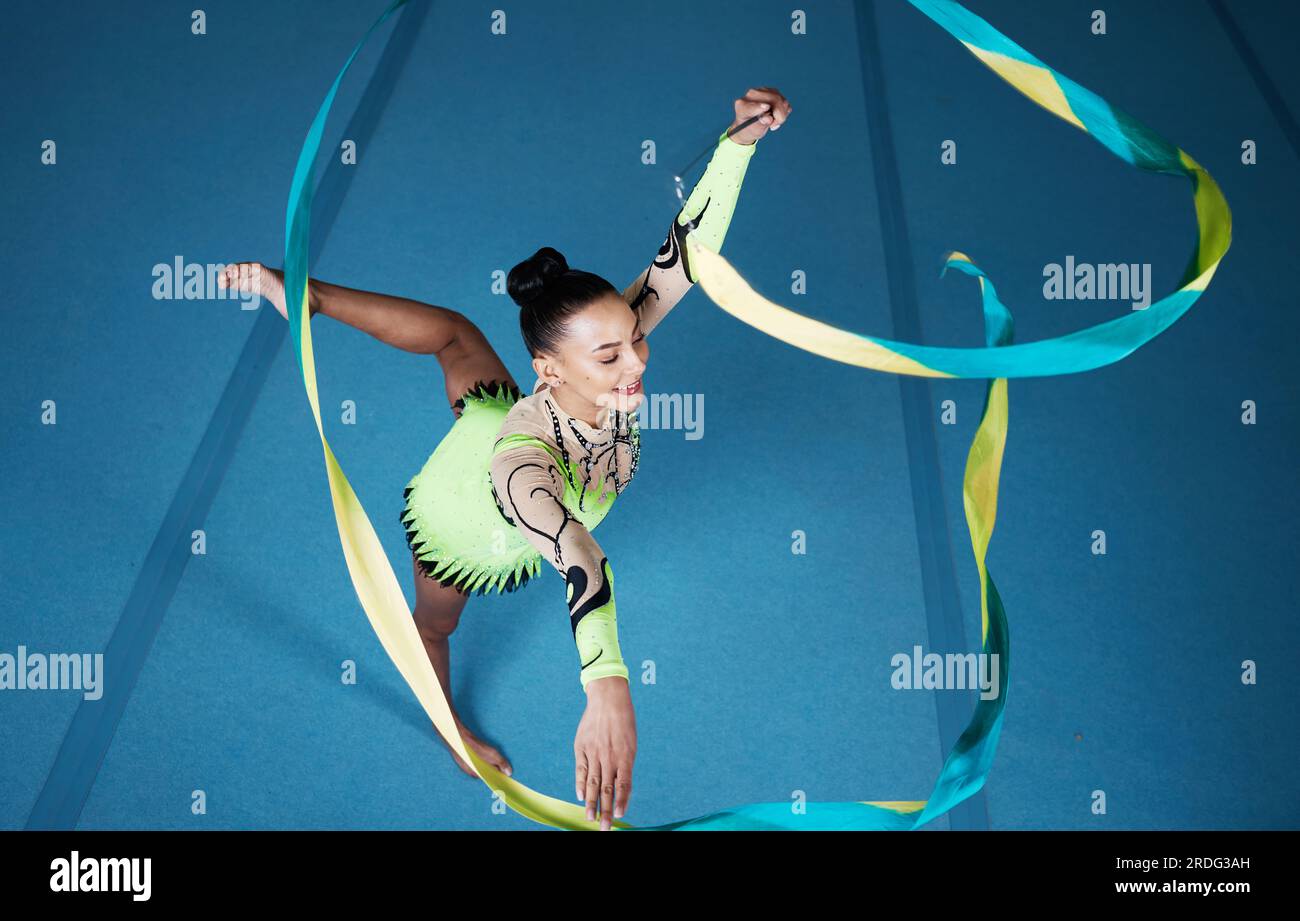 Rhythmic gymnastics, woman in gym and ribbon with balance, action with ...