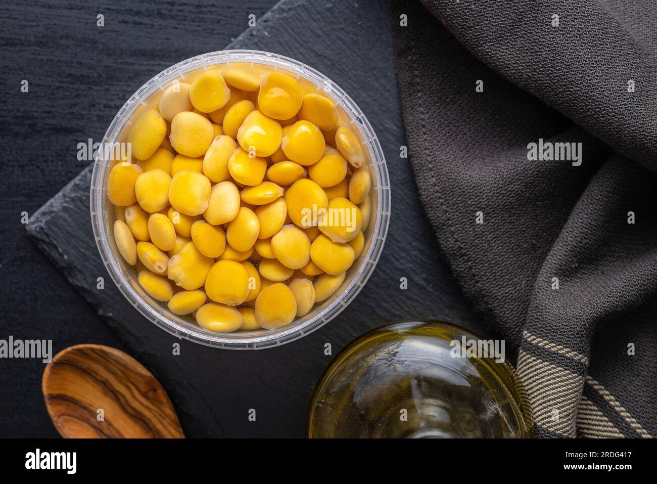Lupini beans in brine. Pickled lupin in bowl on the black table. Top ...