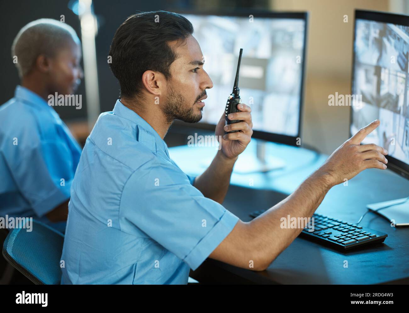 Control room, safety and security guard with a radio and computer ...