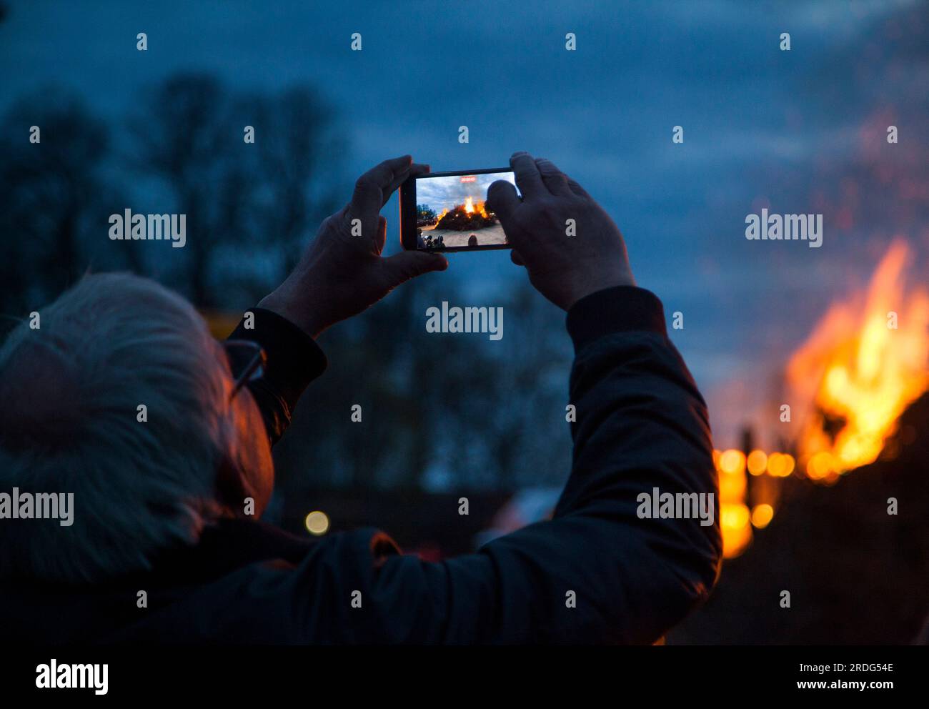 WALPURGIS BONFIRES in Sweden spectators take photos with their mobile ...